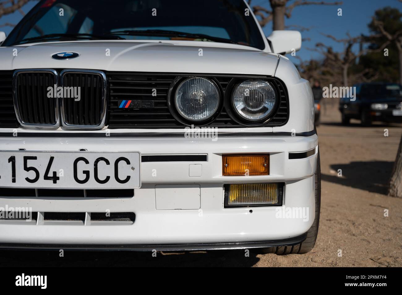Detail of a beautiful German classic, the white BMW E30 M3. Front ...