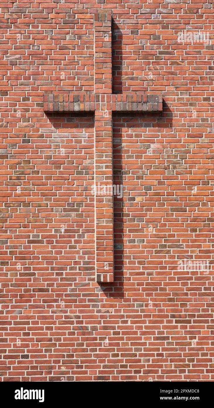 A vertical of a brick cross on a wall of a building Stock Photo - Alamy