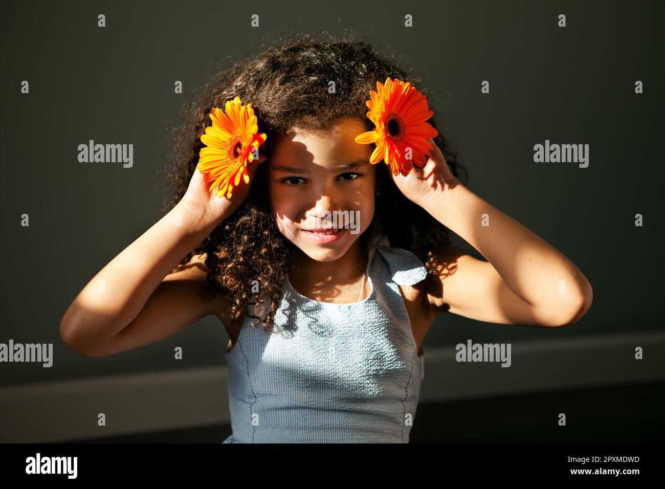 Portrait of beautiful African American child girl with curly hair with ...