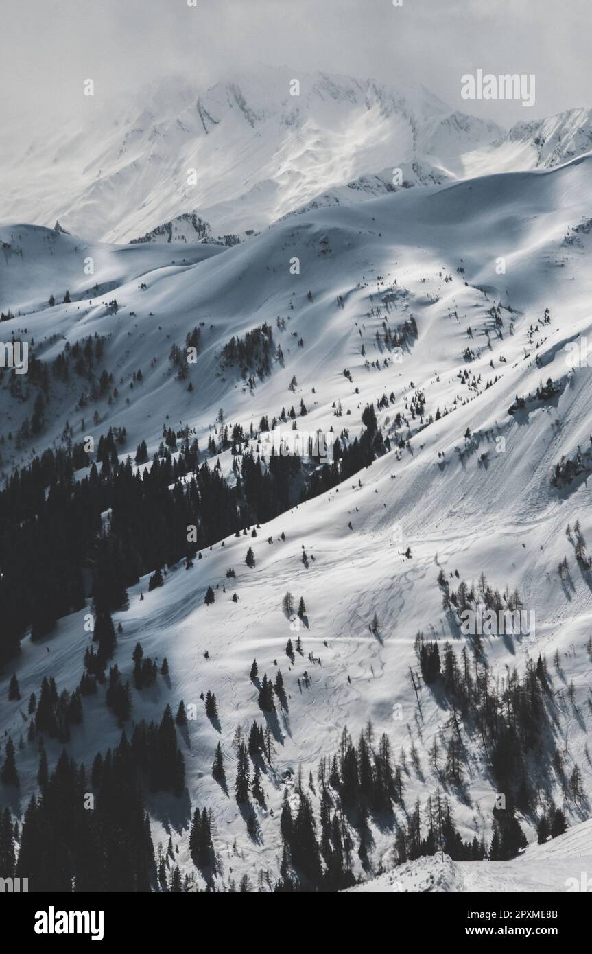 Aerial view of a pristine white snow-covered mountain landscape dotted ...