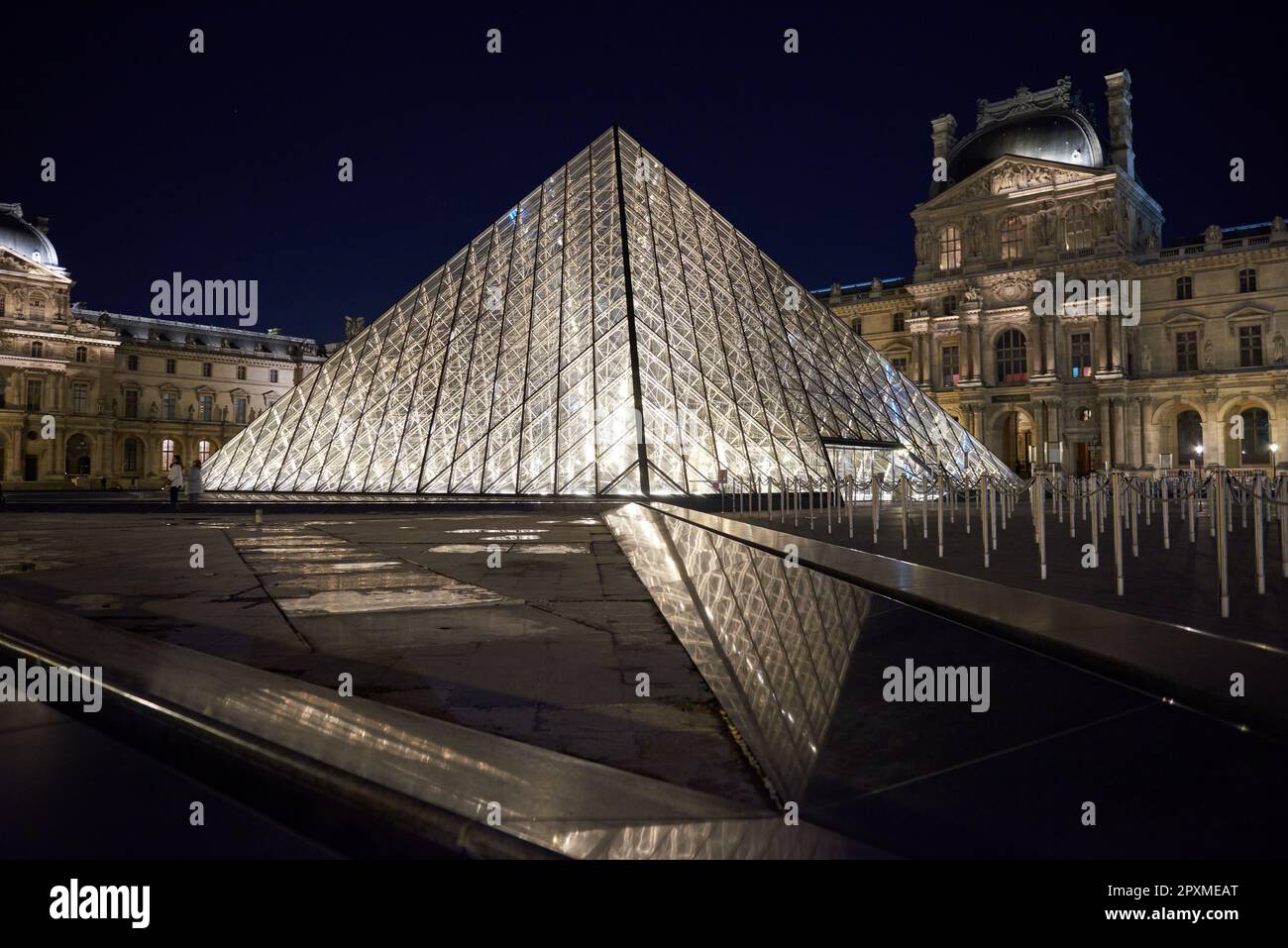 The Louvre Pyramid glows at night in an empty courtyard Stock Photo - Alamy