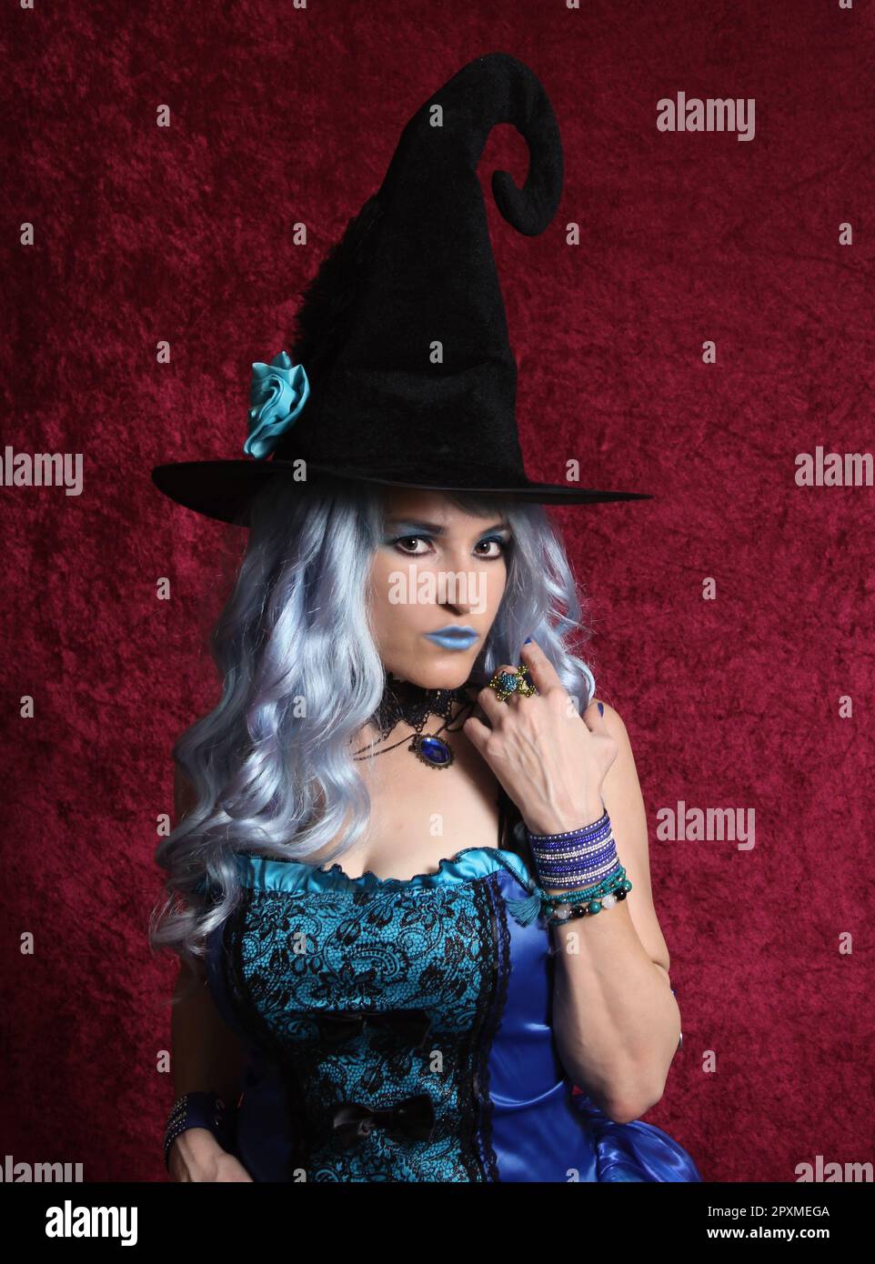Woman Dressed as Blue Witch on Red Velvet Background Stock Photo - Alamy