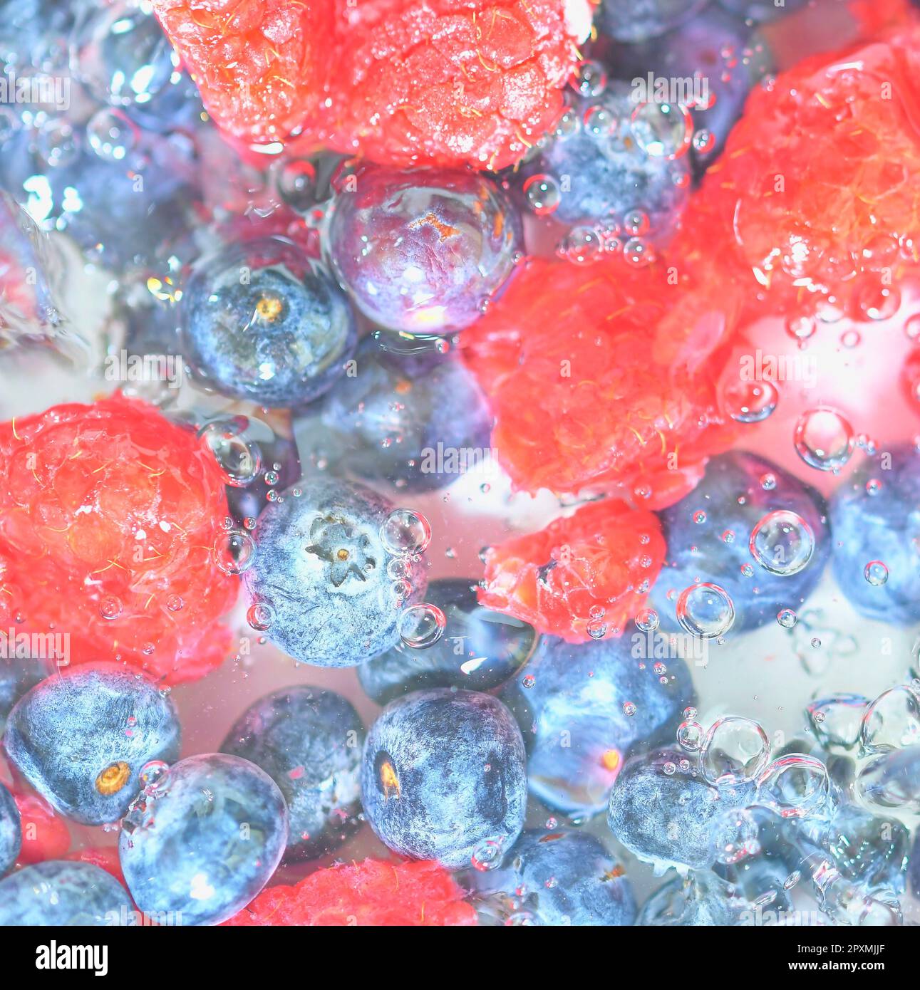 Water with fresh berries, close-up. Close-up view of the blueberries ...