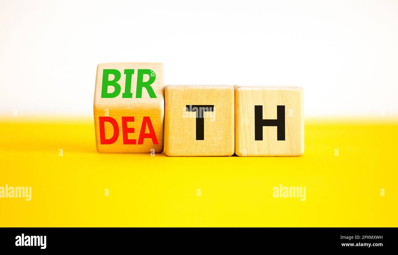 Birth or death symbol. Businessman turns wooden cubes and changes the ...