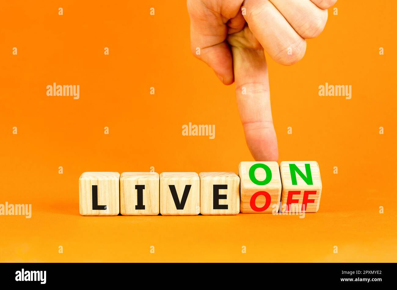 Live on or off symbol. Businessman turns wooden cubes and changes word ...