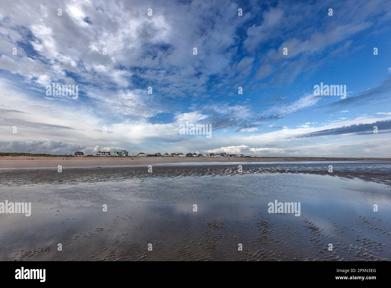 Beach houses in dunes on sunny windy Camber Sands at Rye Bay by English ...