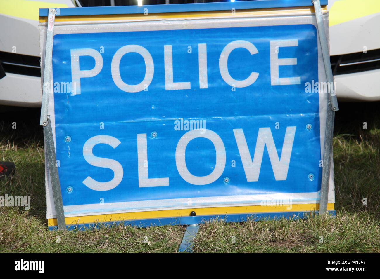 A Police Slow Free Standing Road Traffic Warning Sign Stock Photo - Alamy