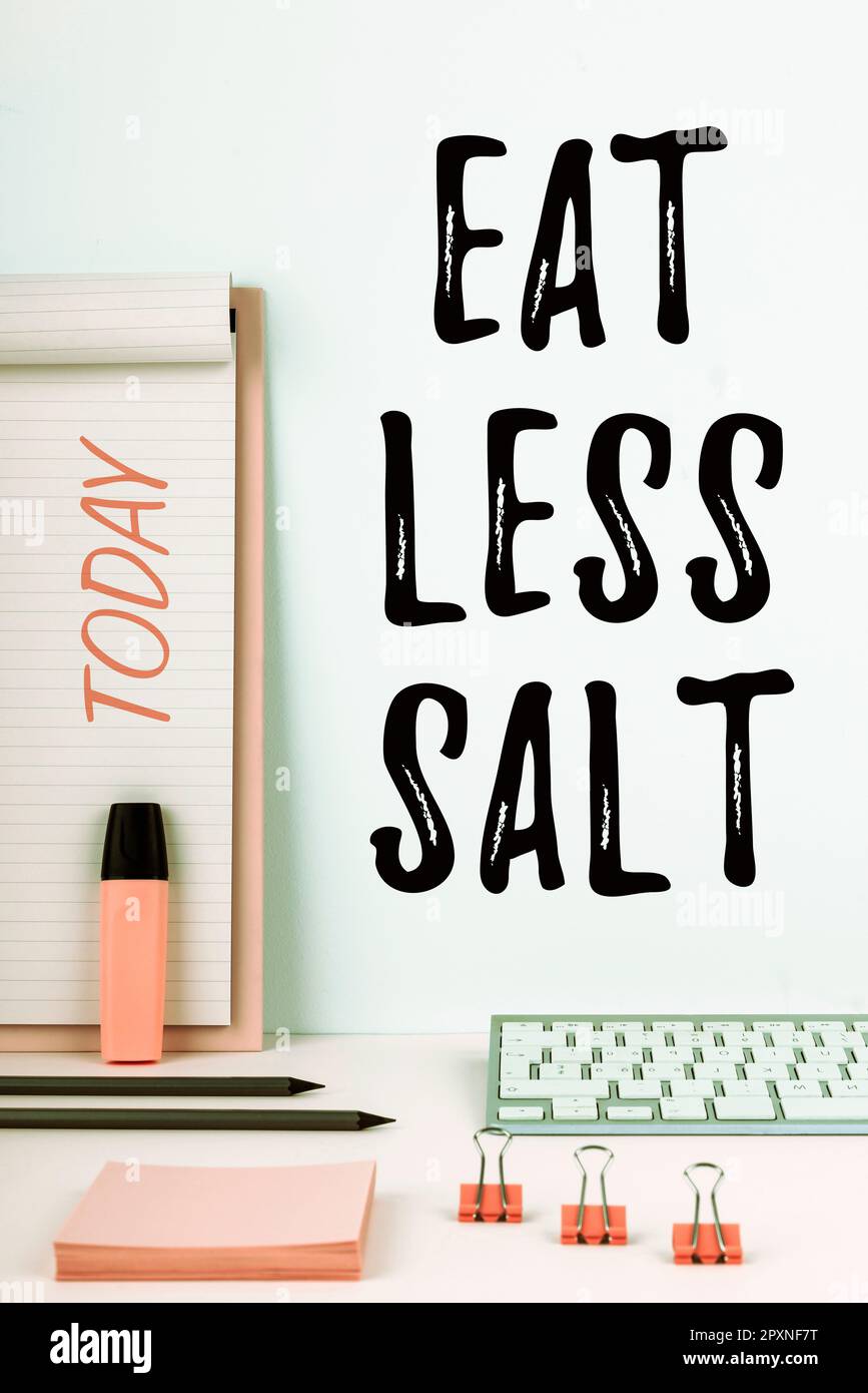 Hand writing sign Eat Less Salt, Word for reducing the sodium intake on ...