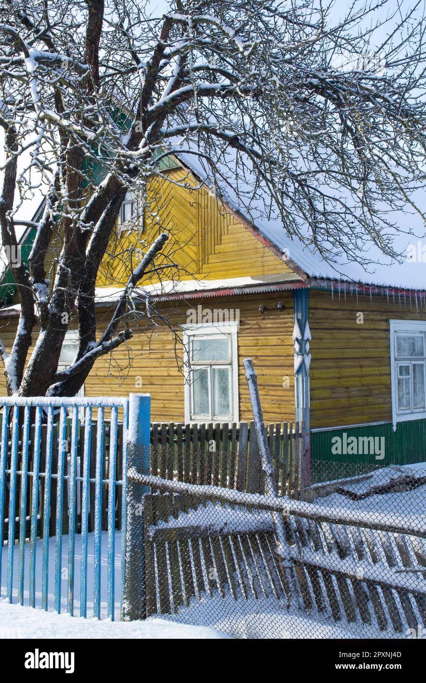 Beautiful wooden house covered with fresh snow. Old winter village cozy ...