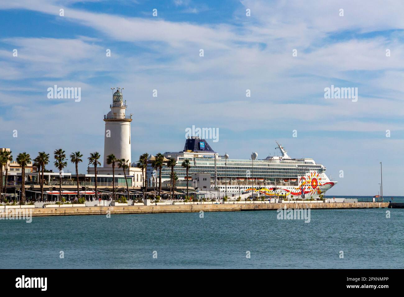 Cruise ship next to the lighhouse in the Port of Malaga on the Costa ...