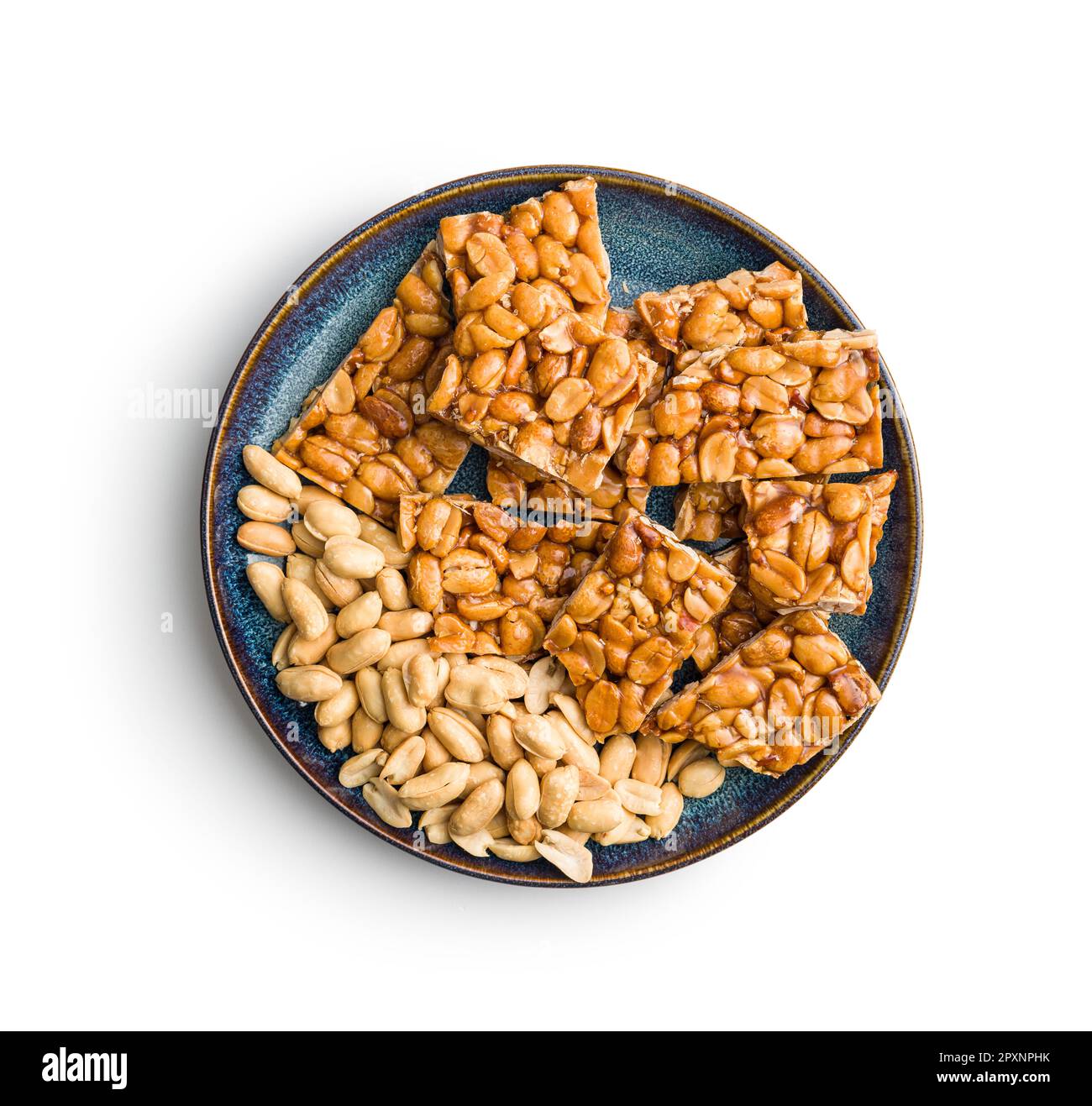 Sweet peanut brittle on plate. Tasty peanuts in caramel isolated on the ...