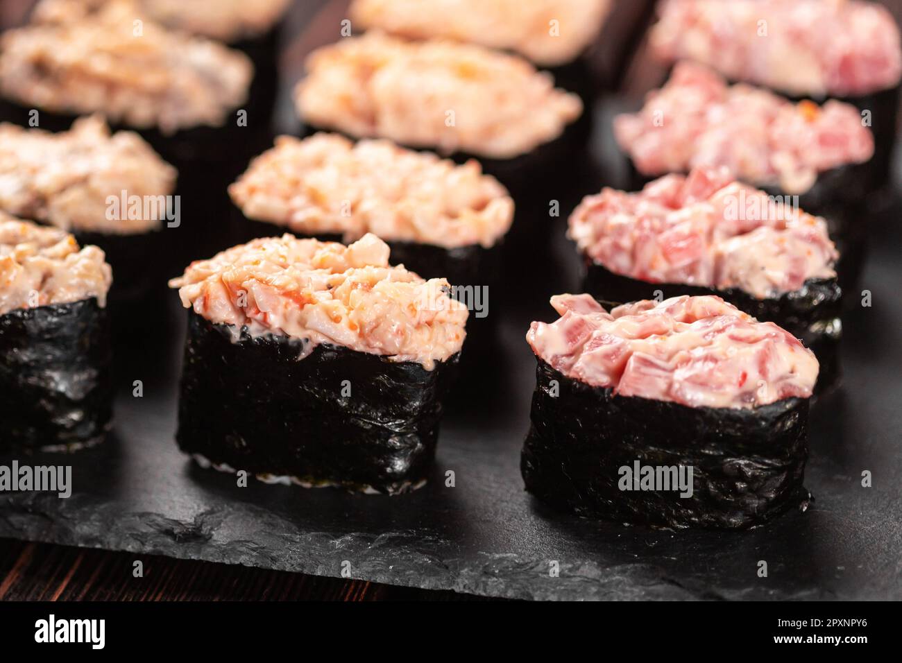 Set of Gunkan Maki Sushi with different types of fish salmon, scallop, perch, eel, shrimp and ...