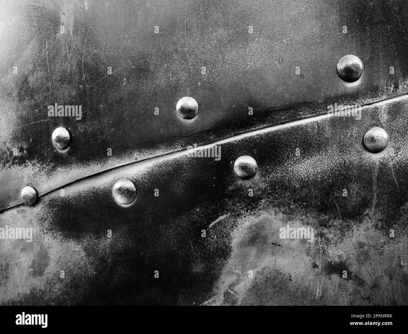 Metal surface with rivets and bolts. Abstract background of a military ...