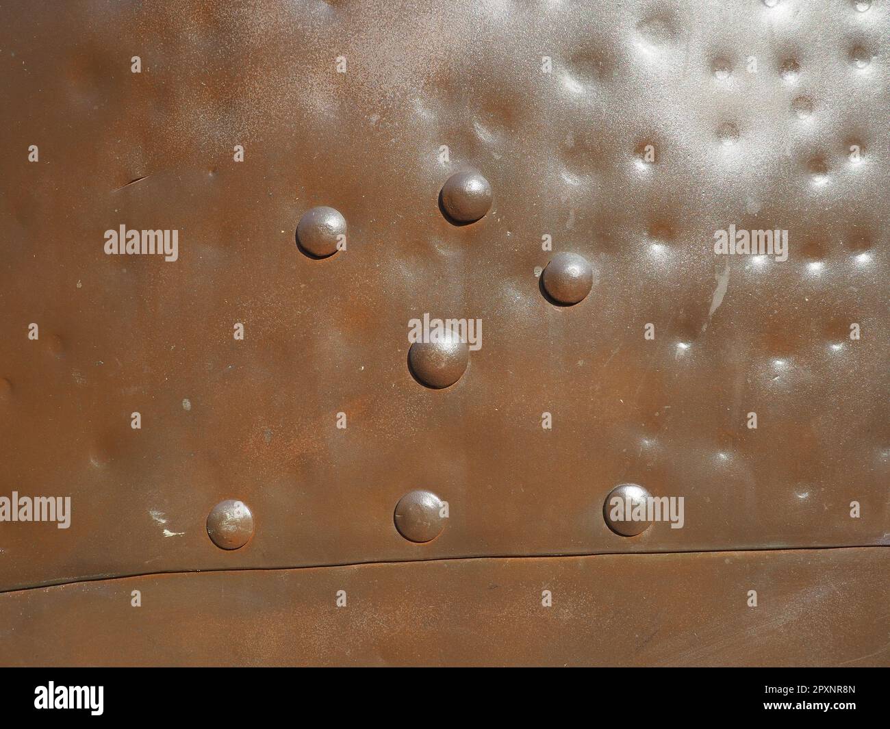 Metal surface with rivets and bolts. Abstract background of a military ...