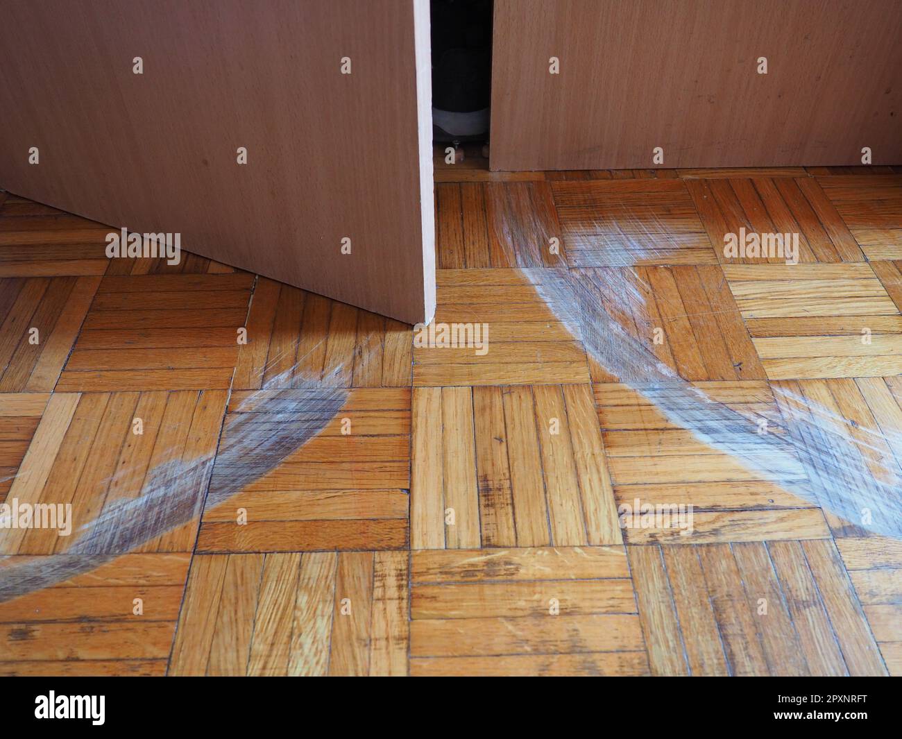 Scratched parquet flooring in the room. Scratches, chips and dents on ...