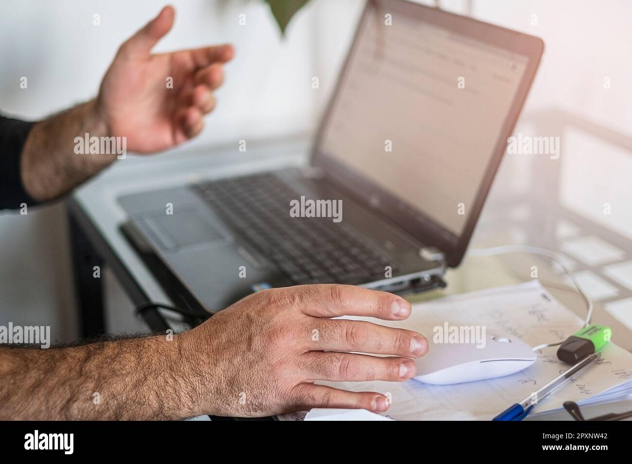 A man's using laptop hand on mouse and shows the screen Stock Photo - Alamy