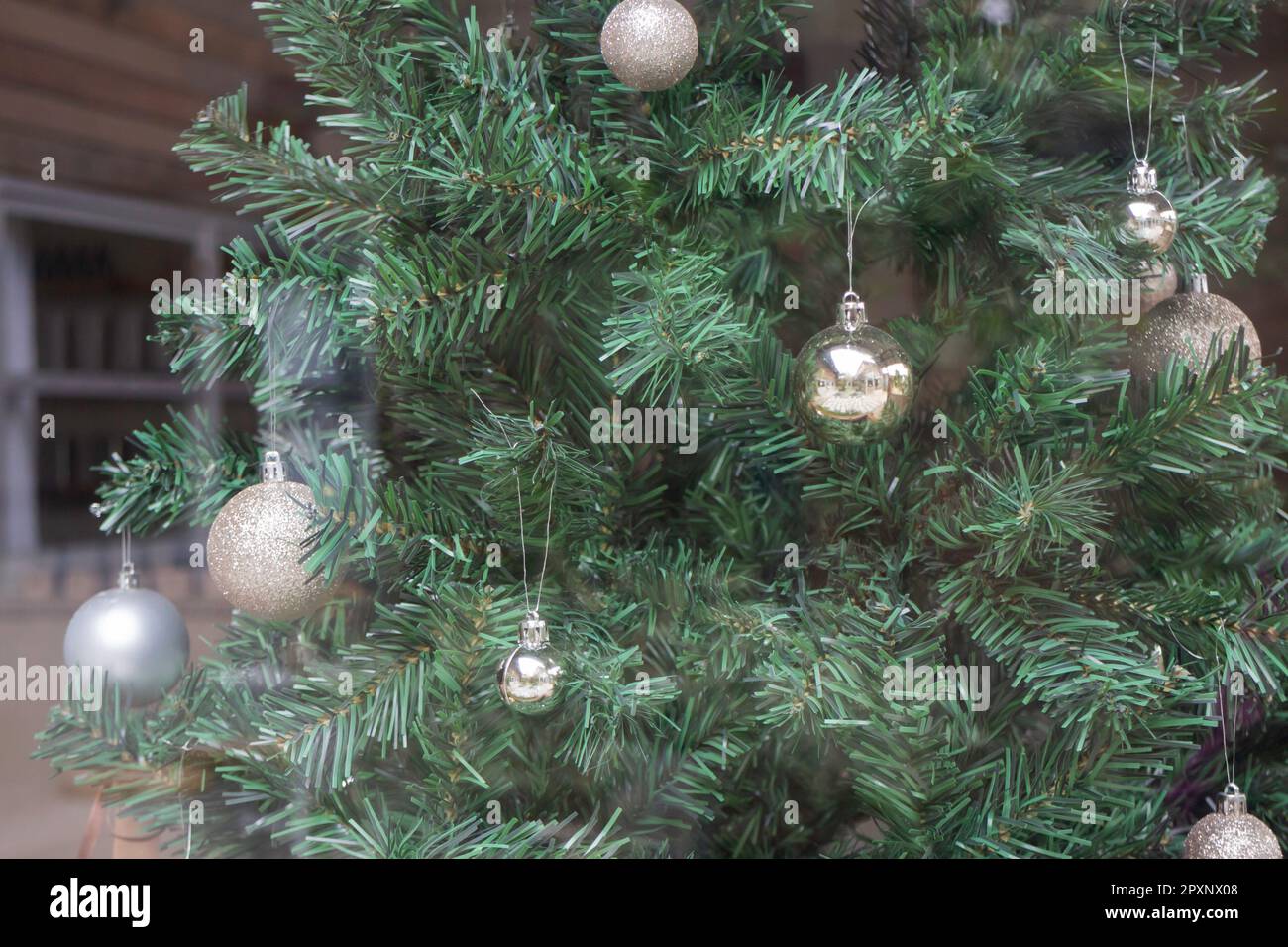 Christmas tree decor on the window of a wooden house, stock photo Stock ...