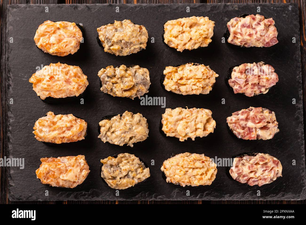 Set of Gunkan Maki Sushi with different types of fish salmon, scallop, perch, eel, shrimp and ...