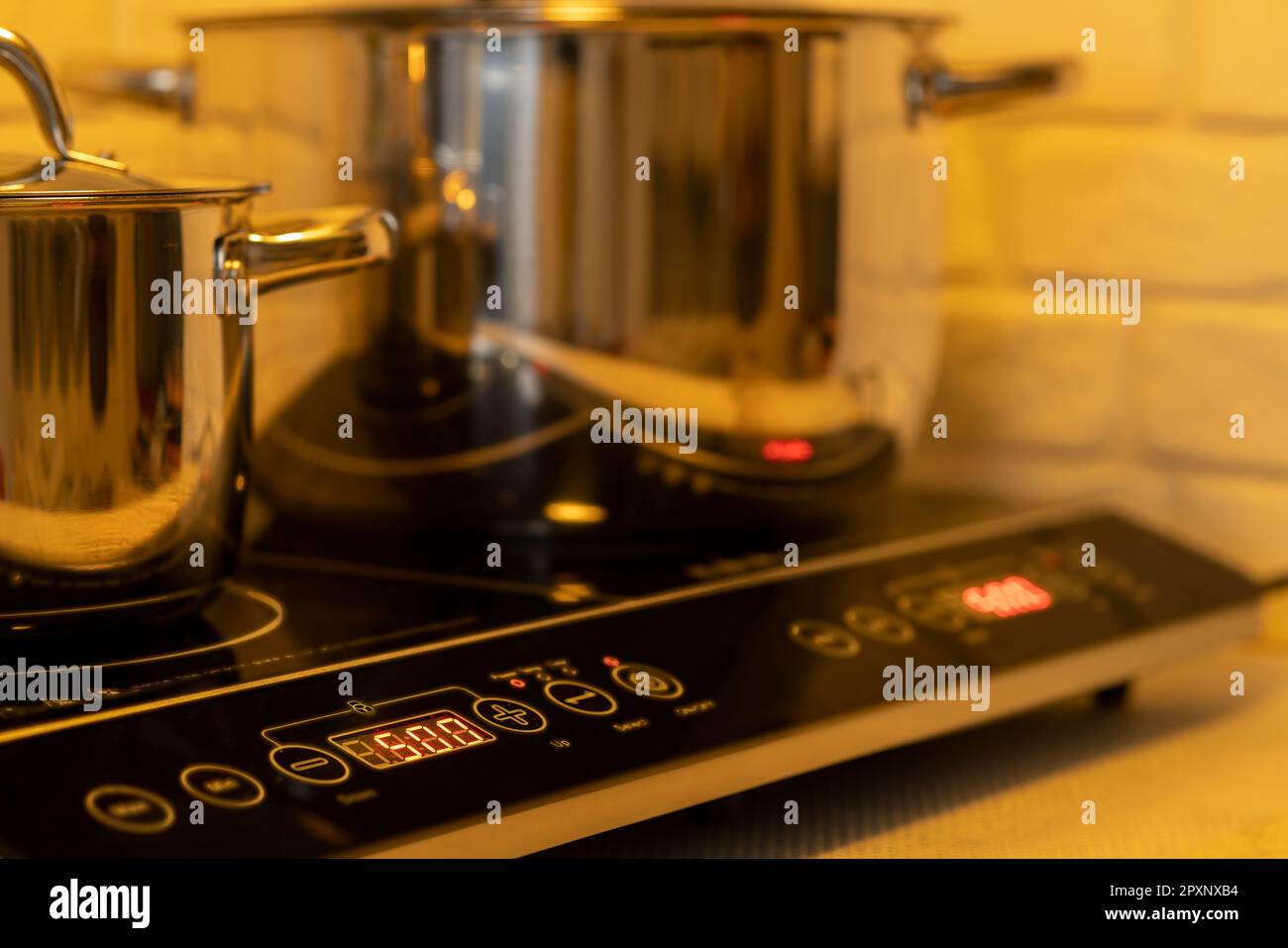 Metal Pot on induction hob in modern kitchen Stock Photo - Alamy