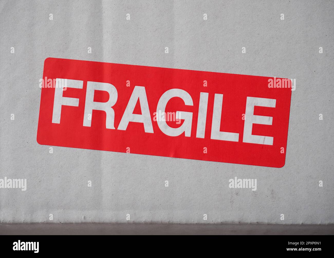 fragile warning sign label tag on a cardboard box Stock Photo - Alamy