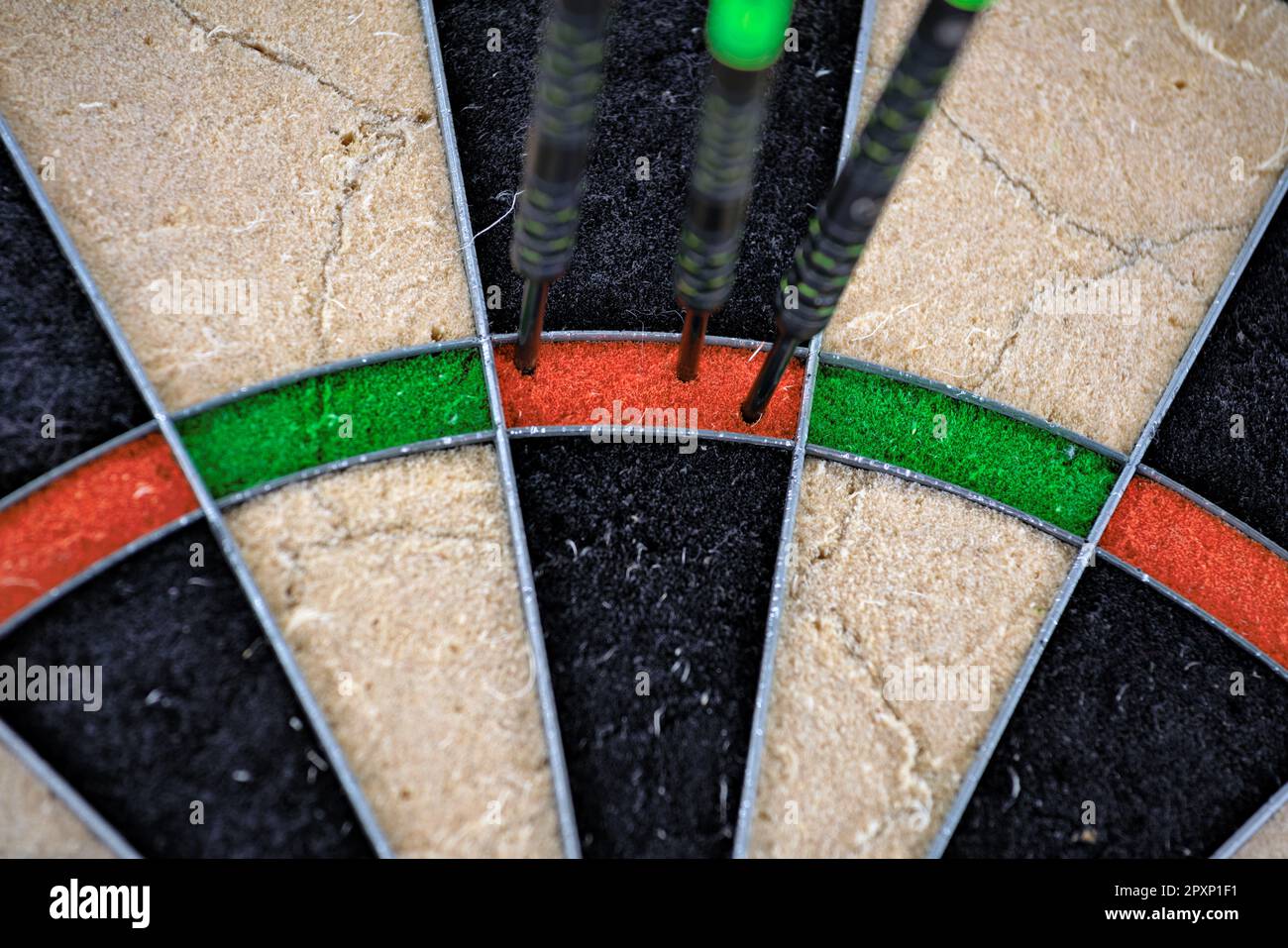 Three darts stuck in the Triple 20 of a dartboard. 180 points. Close-up ... Three darts stuck in the Triple 20 of a dartboard. 180 points. Close-up ...