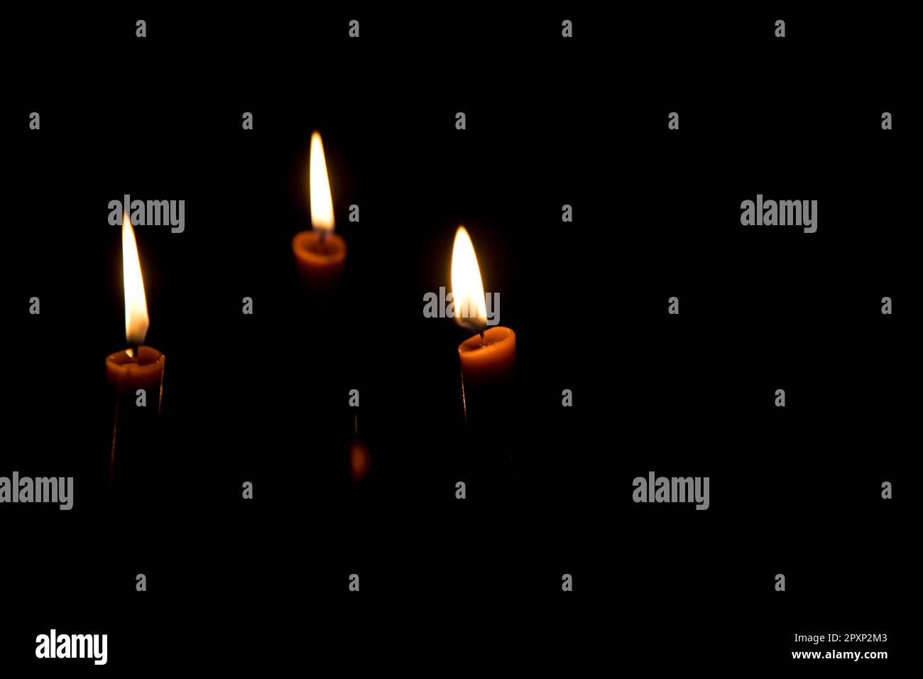 Set burning candles in dim hi-res stock photography and images - Alamy