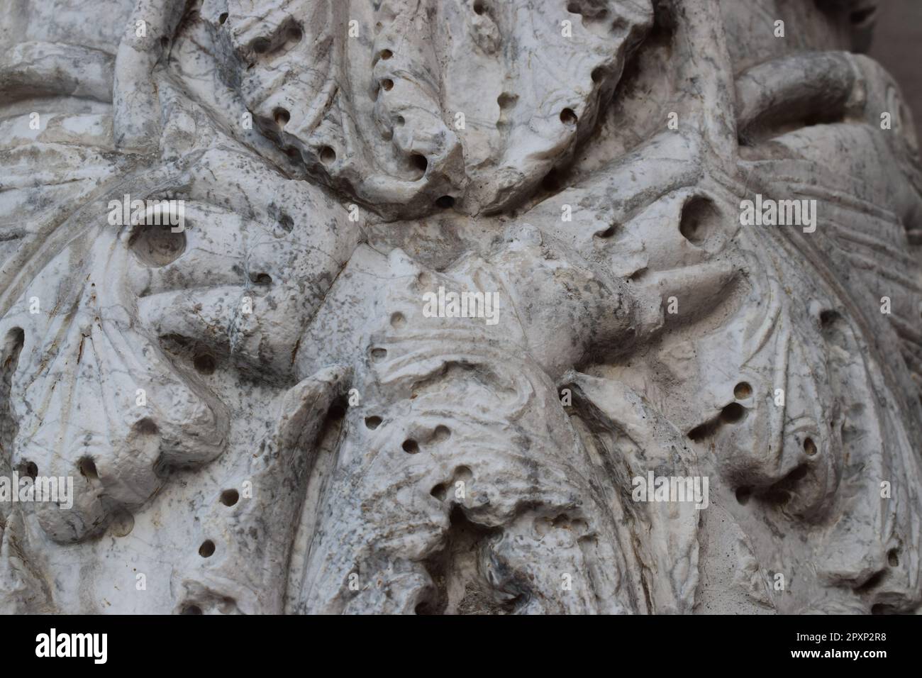 A detailed carving of a floral pattern on the exterior of a column with ...