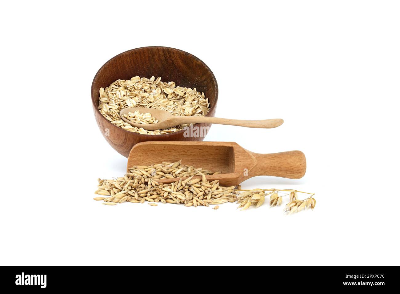 Oat grains with hulls or husks in wooden scoop and oats groats rolled ...