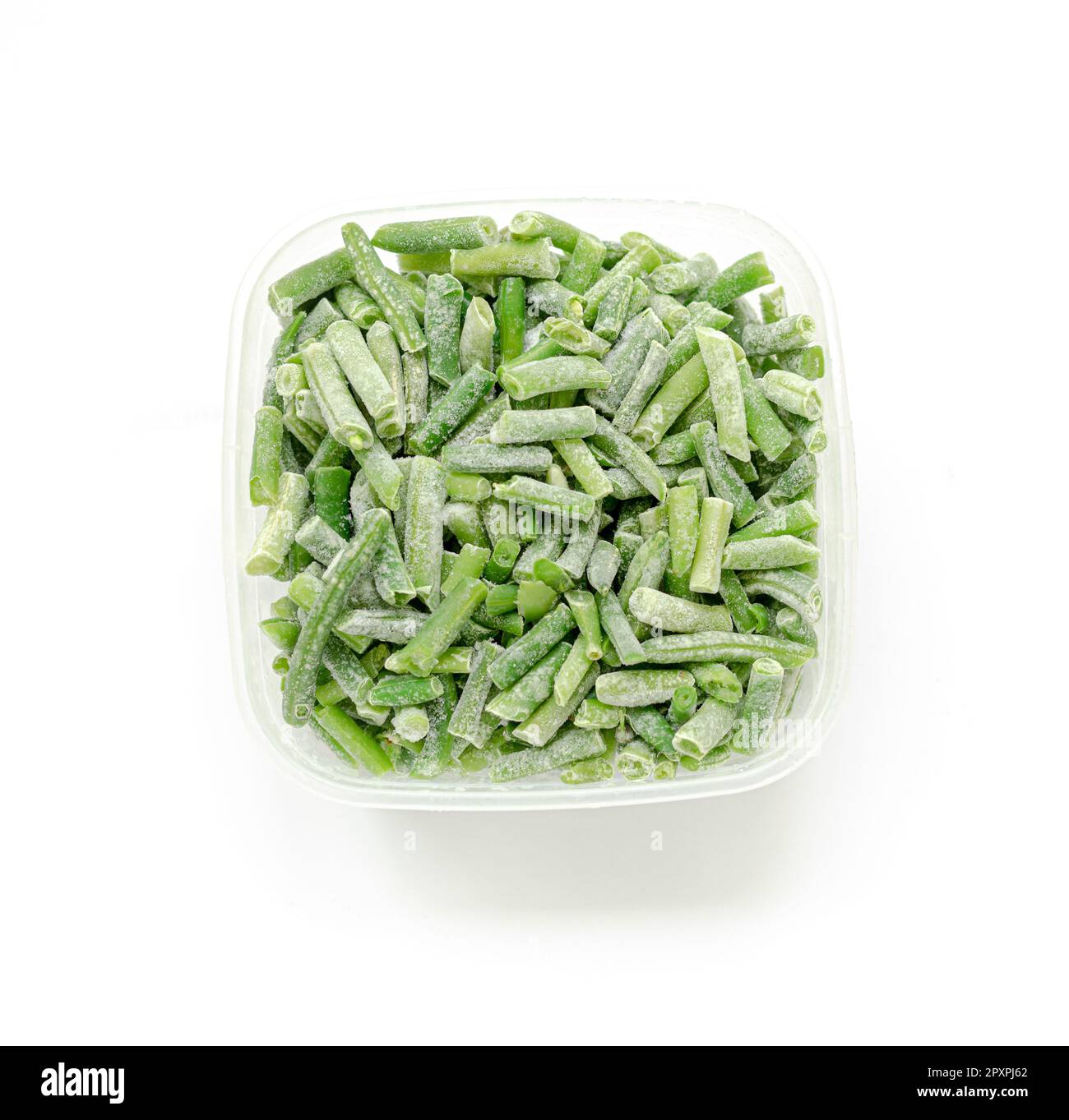 Frozen cut green beans in square plastic bowl on white background ...