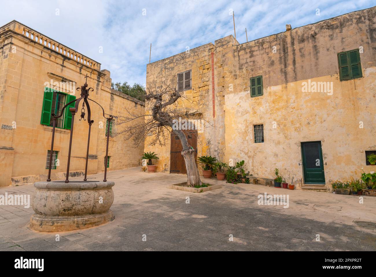 A view of old Mdina street with a traditional Maltese style openwork ...