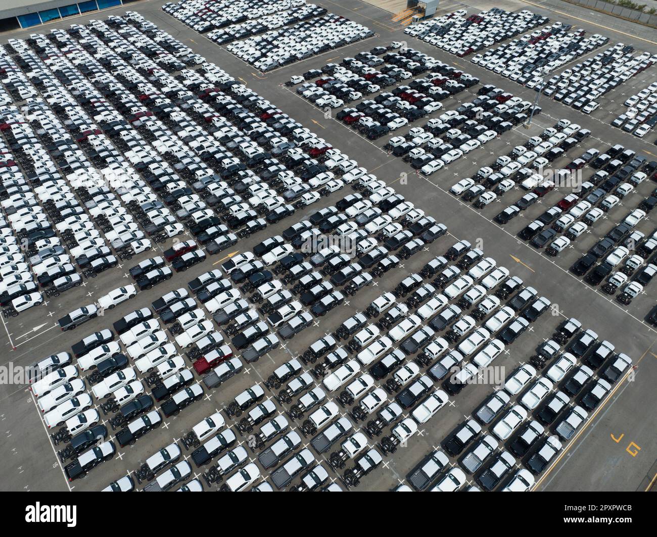 Aerial view of new cars stock at factory parking lot. Above view cars ...