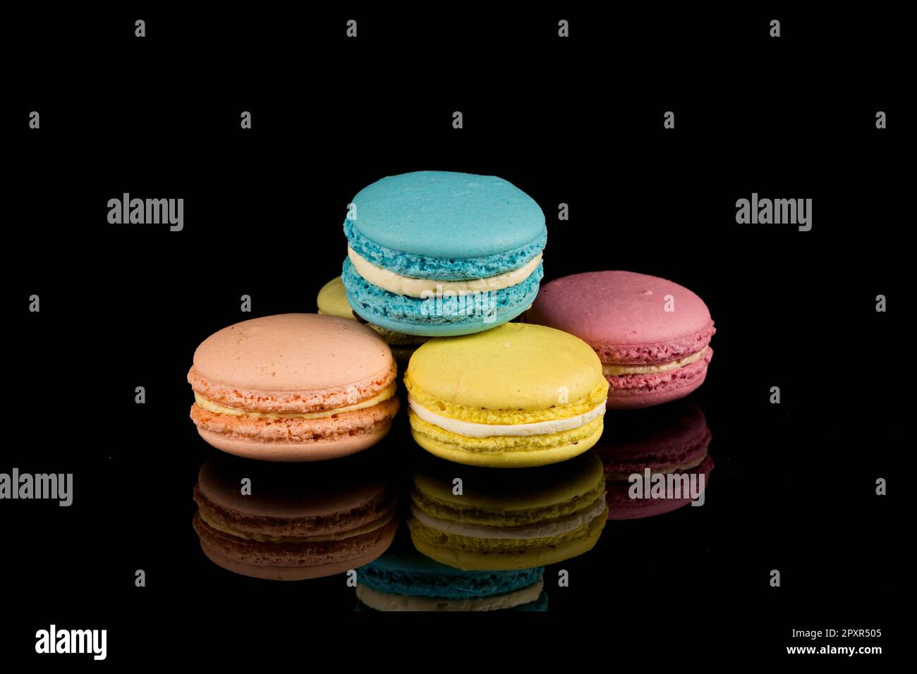 Colorful macaroons over a black background with reflection Stock Photo ...