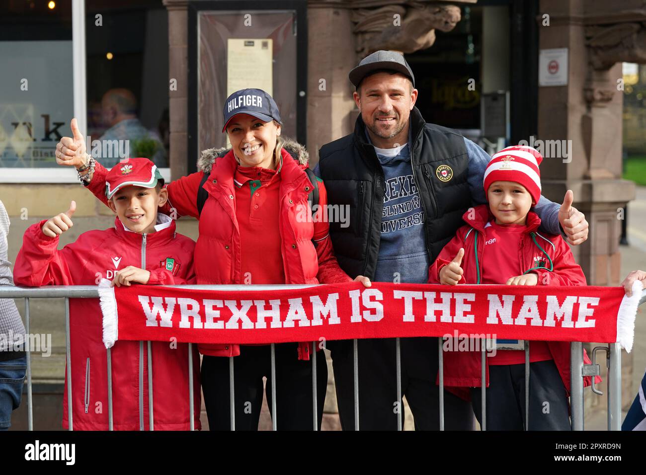 Wrexham fans pose behind a boundary during a victory parade in Wrexham ...