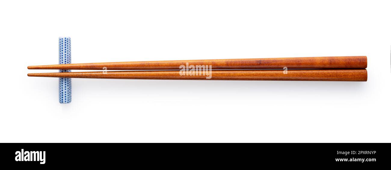Wooden chopsticks and chopstick rests placed on a white background ...