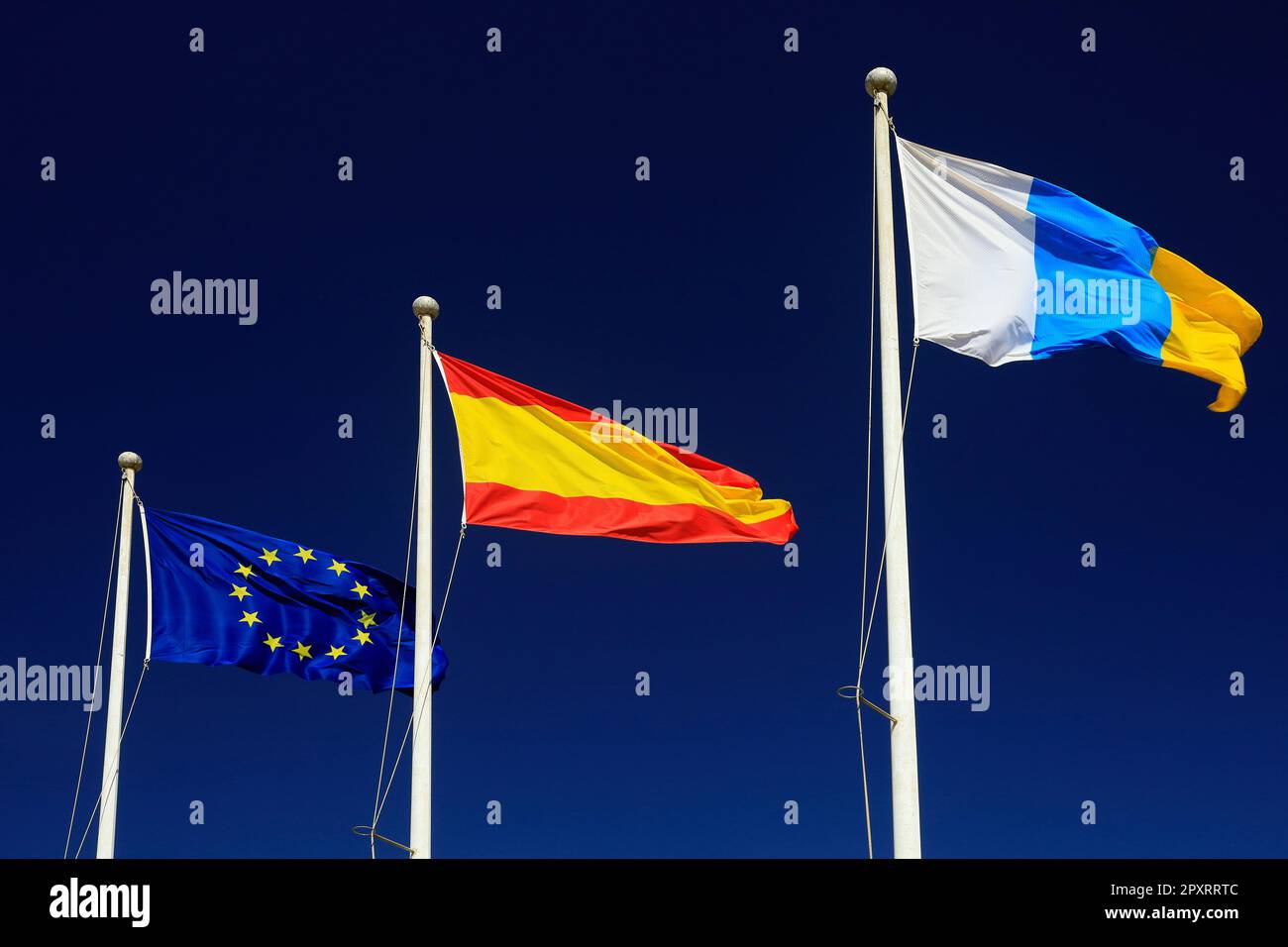Three flags against blue sky, Lanzarote Taken February 2023. From left ...