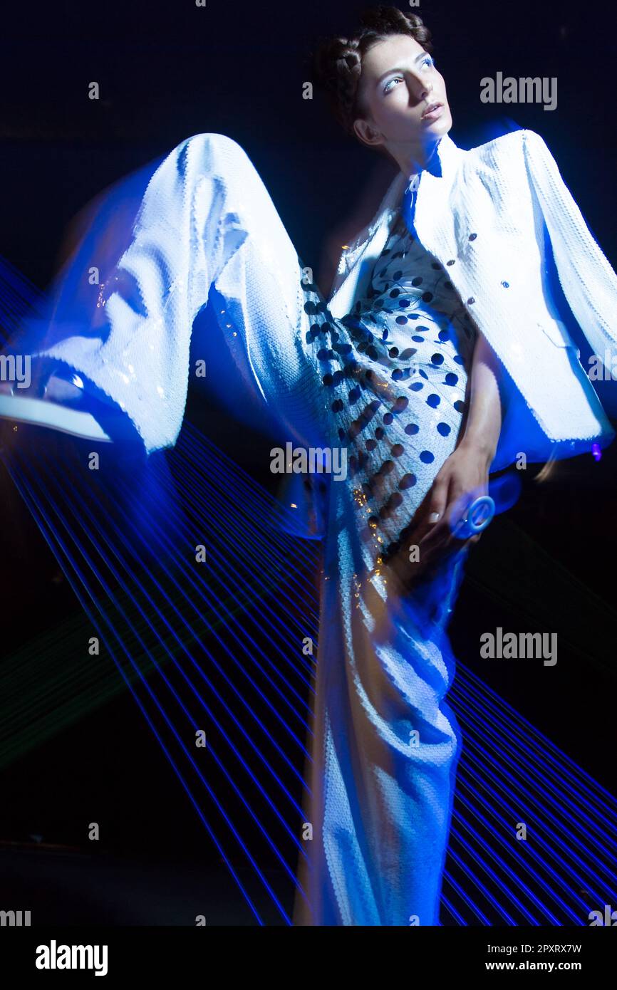 Fashion model beautiful girl in fashionable clothes in ultraviolet ...