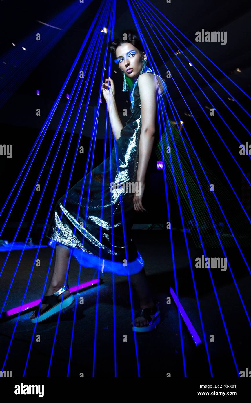 Fashion model beautiful girl in fashionable clothes in ultraviolet ...
