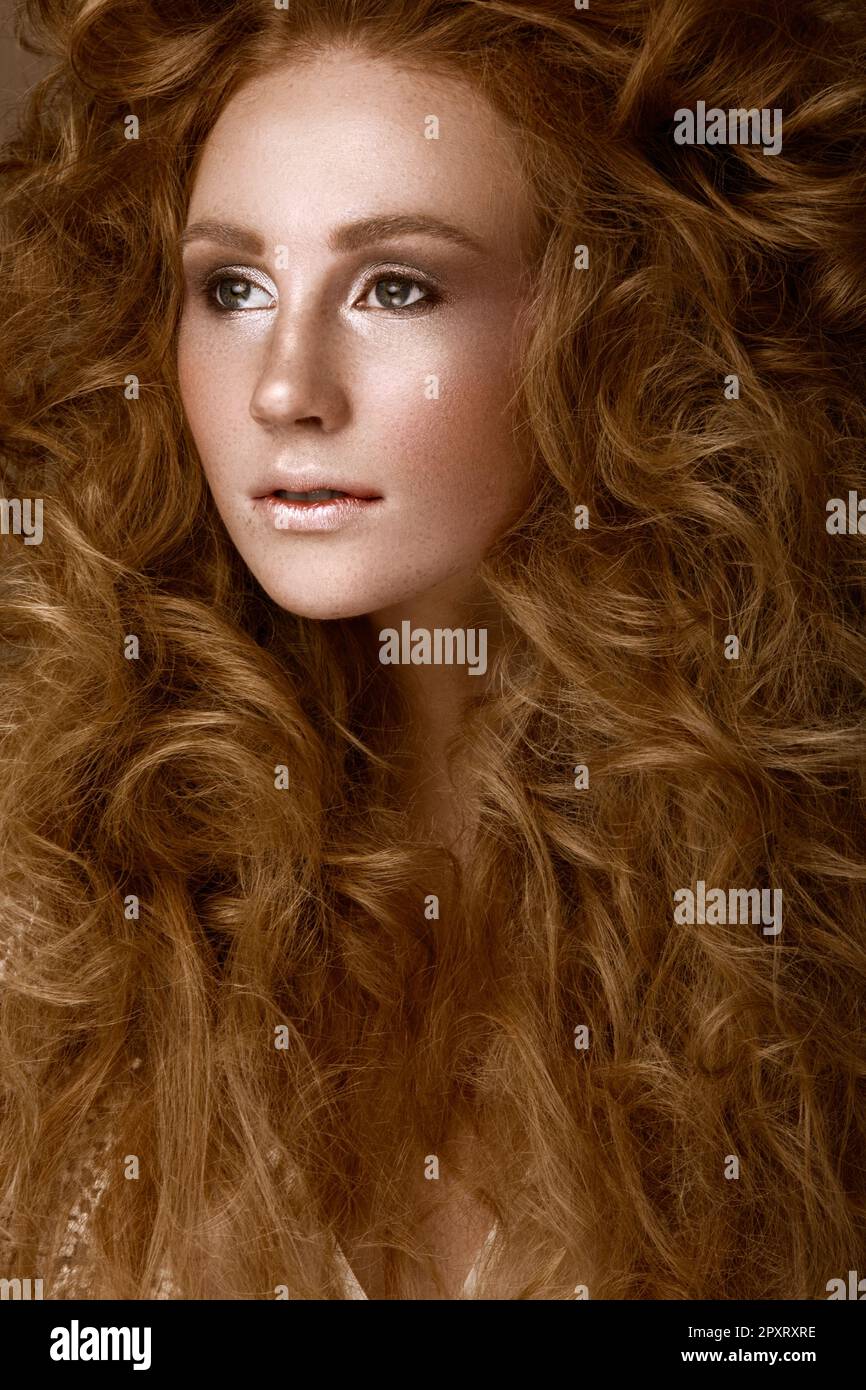 Beautiful Redhead girl with a perfectly creative curls hair and classic make-up Stock Photo - Alamy