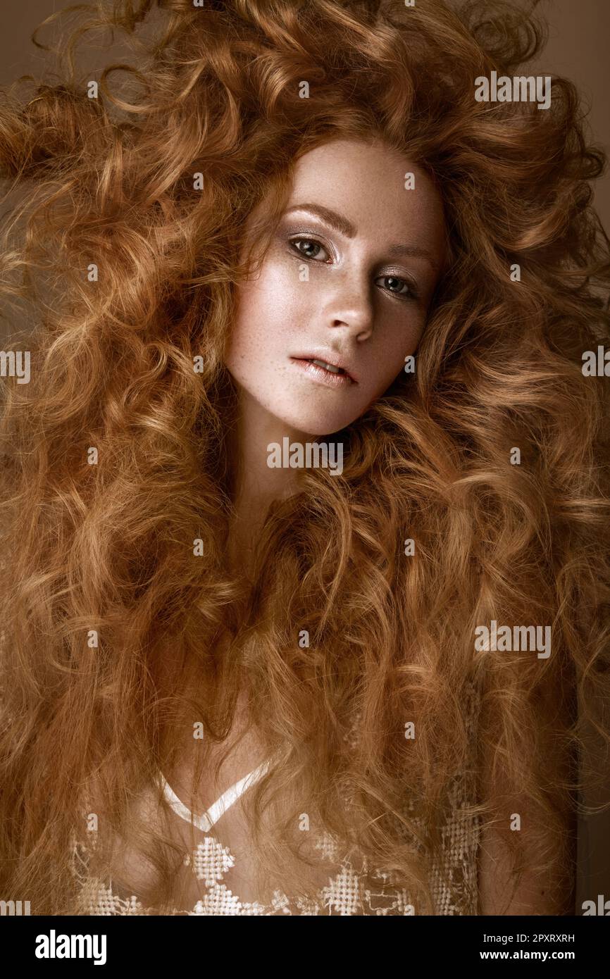 Beautiful Redhead girl with a perfectly creative curls hair and classic make-up Stock Photo - Alamy