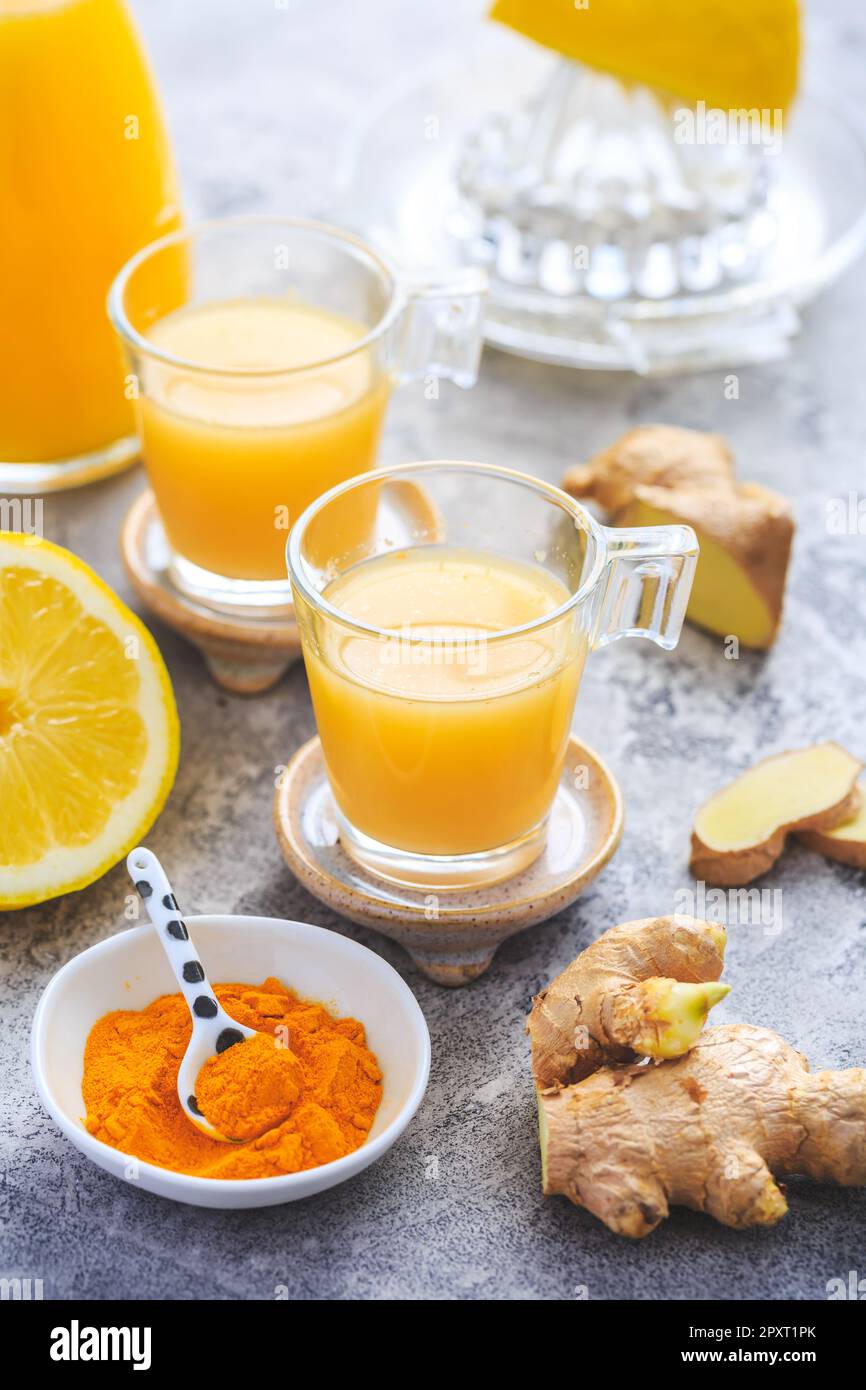 Homemade turmeric lemon ginger shots in small glasses, healthy Ginger ...