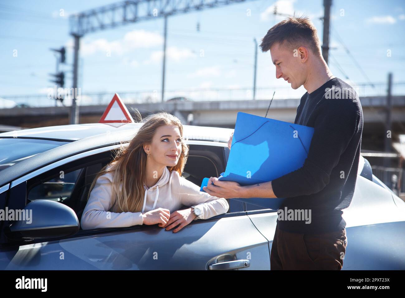The driver is an auto school instructor and a female student on an ...