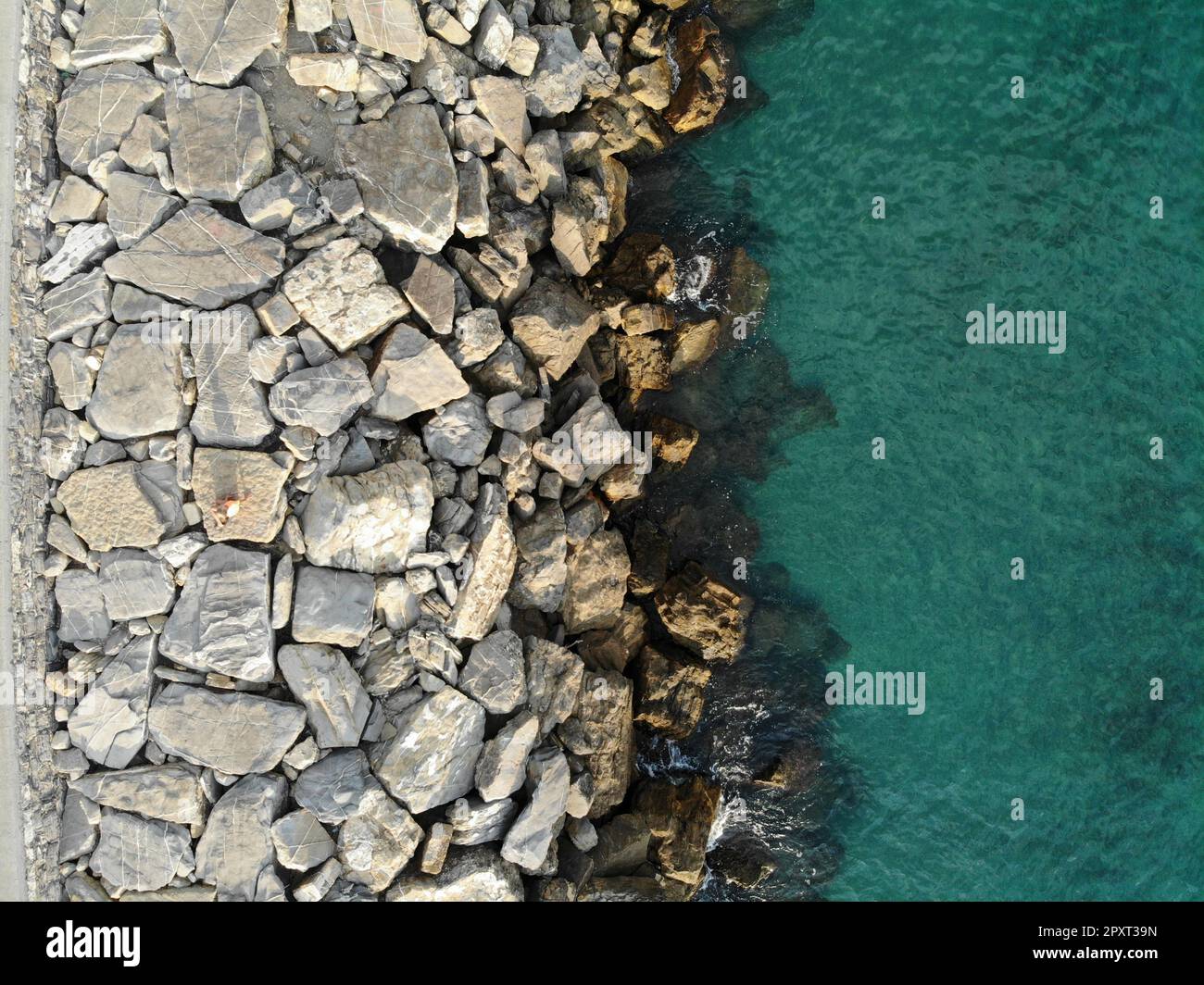 An Aerial view of a crystal clear ocean near a rocky shoreline Stock ...