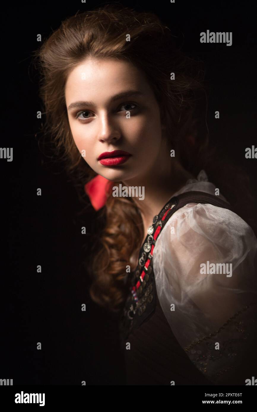 Beautiful Russian Girl In National Dress With A Braid Hairstyle And Red