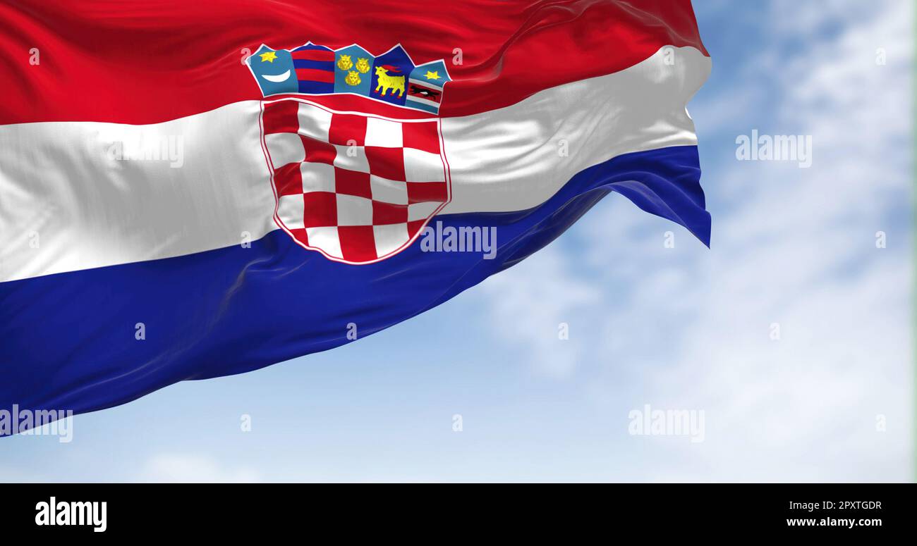 The national flag of Croatia waving in the wind on a clear day. Red ...