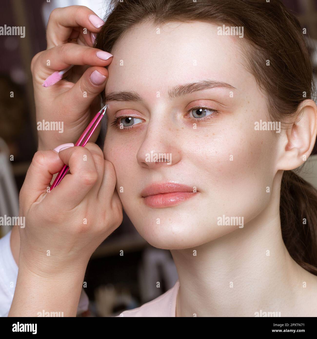 Permanent microblasting tattooing freckles to a woman in a beauty salon ...