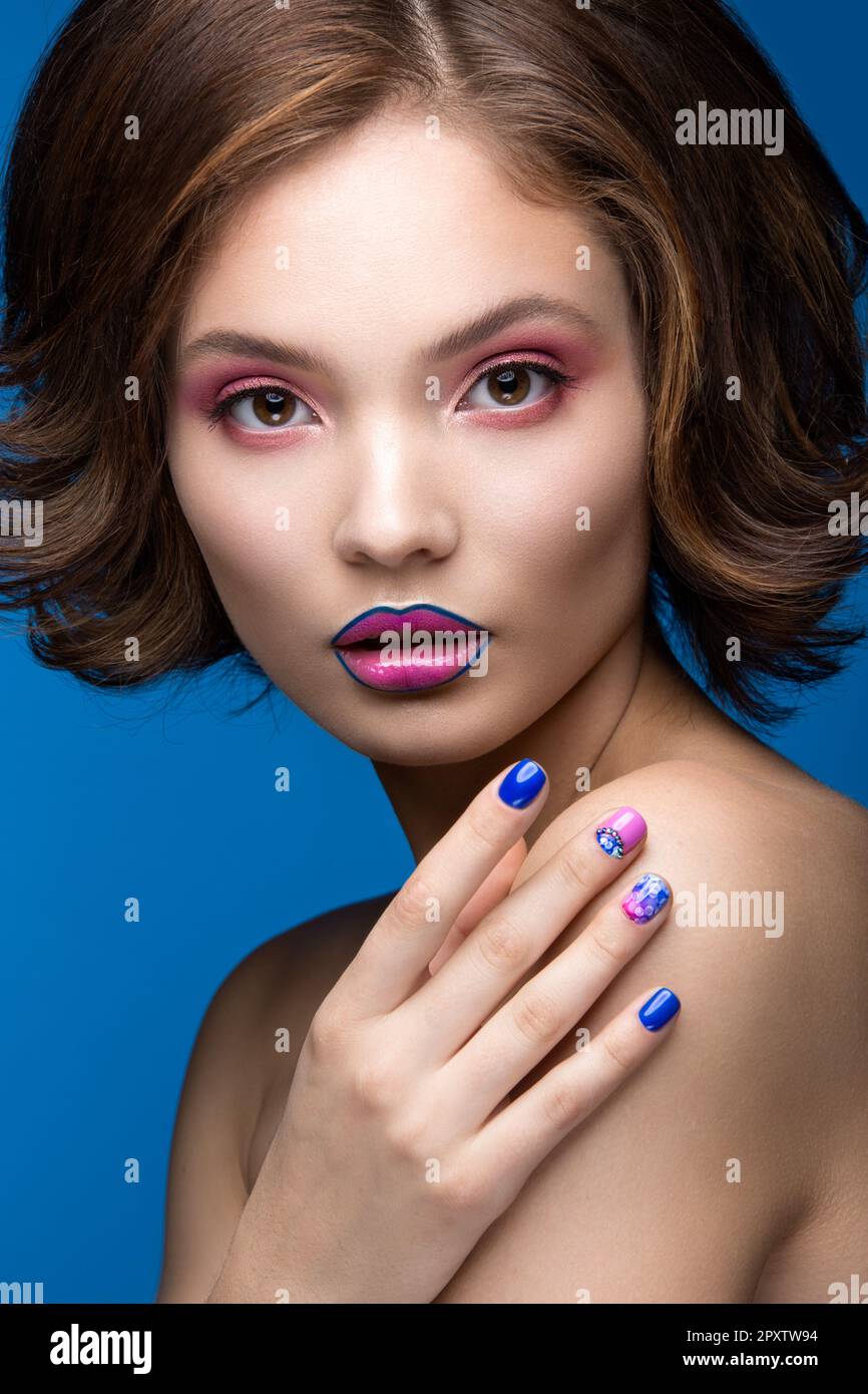 Beautiful model girl with bright makeup and colored nail polish. Beauty ...