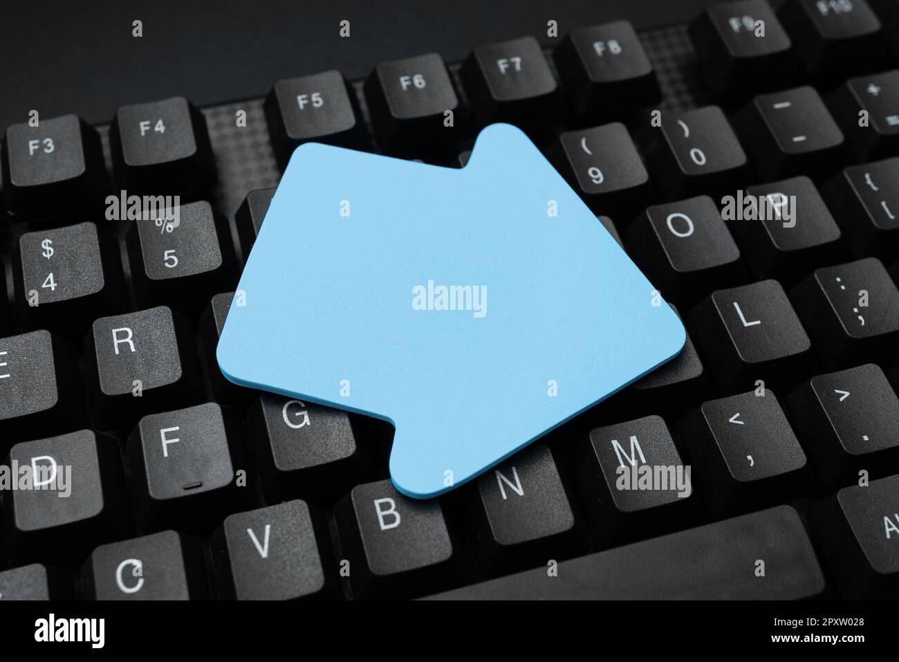 Colored sticker lying on keyboard. Important message written over paper ...