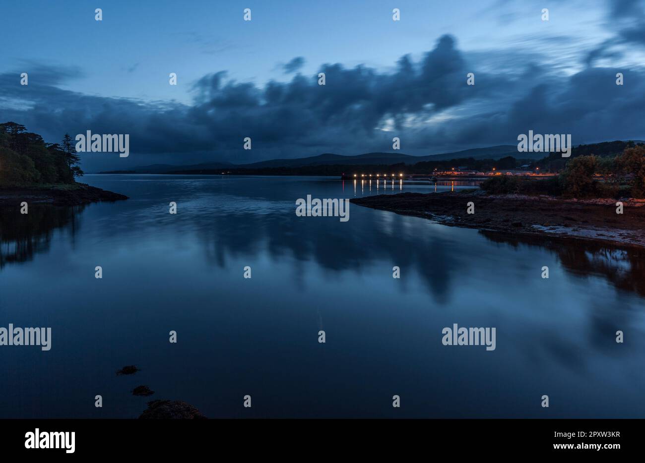 Peaceful, calm, serene Kenmare bay with pier at twilight or night with ...