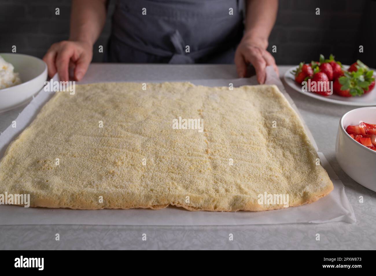 Plain sponge cake base, square shape ready to get filled on kitchen ...