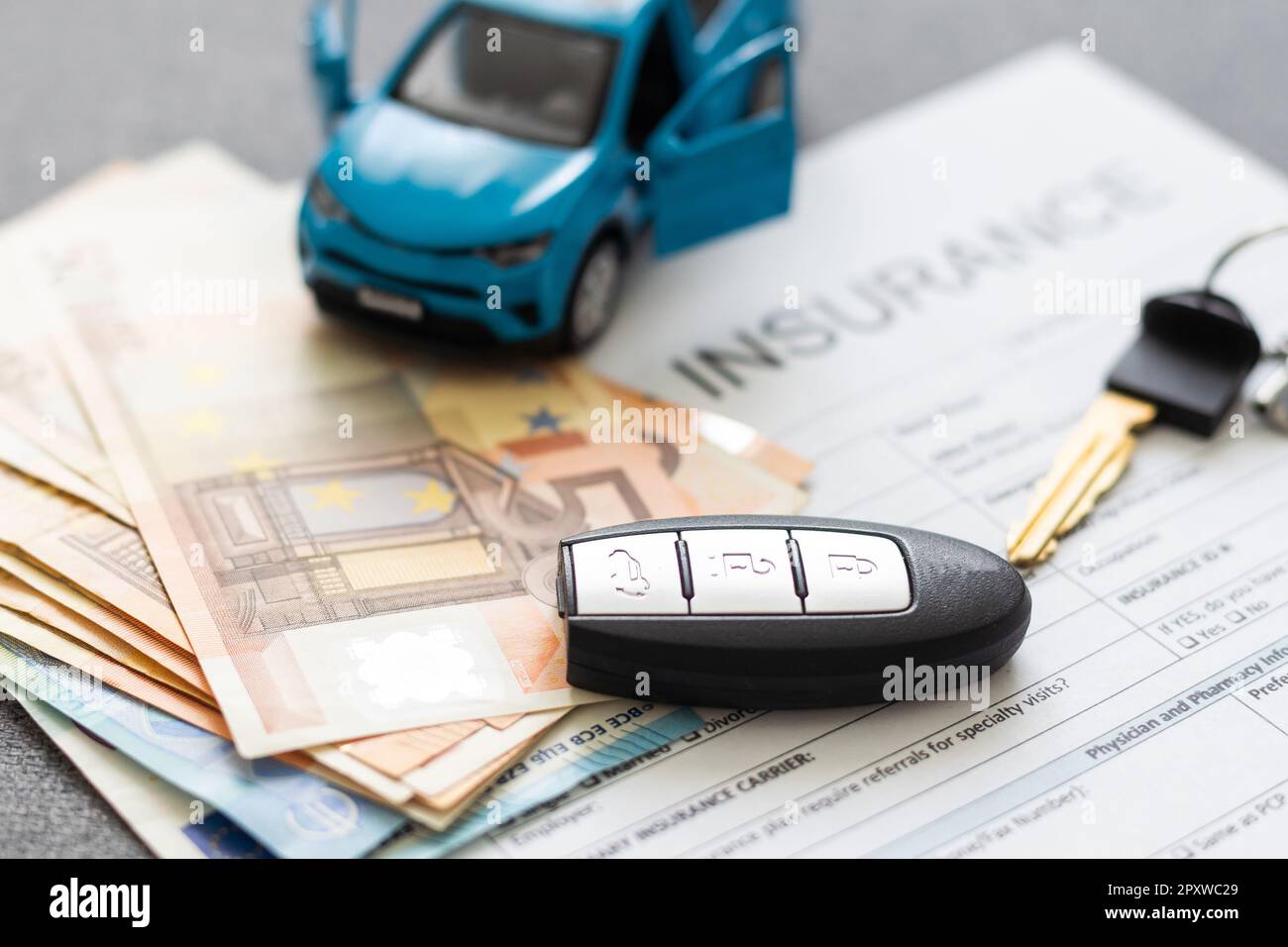 Car insurance form with car key and toy car Stock Photo - Alamy